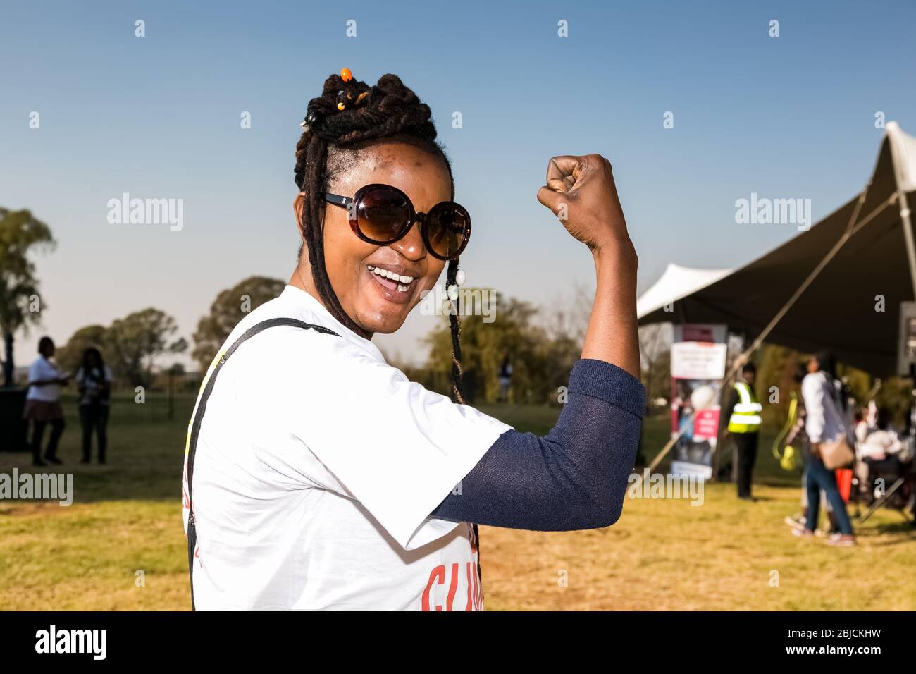 African woman flexing biceps hi-res stock photography and images - Alamy
