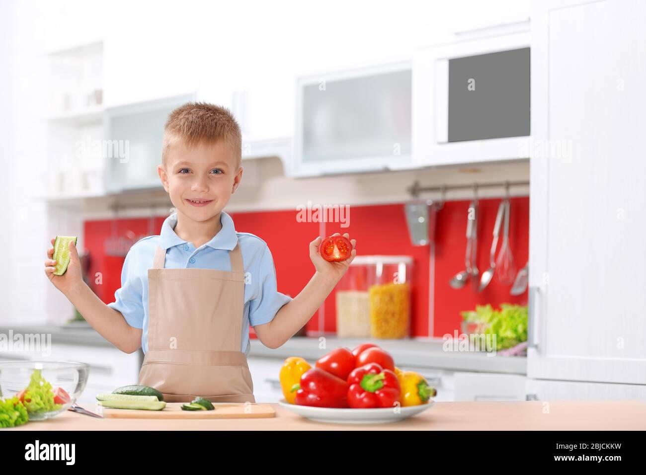 Little boy cooking in the kitchen Stock Photo - Alamy