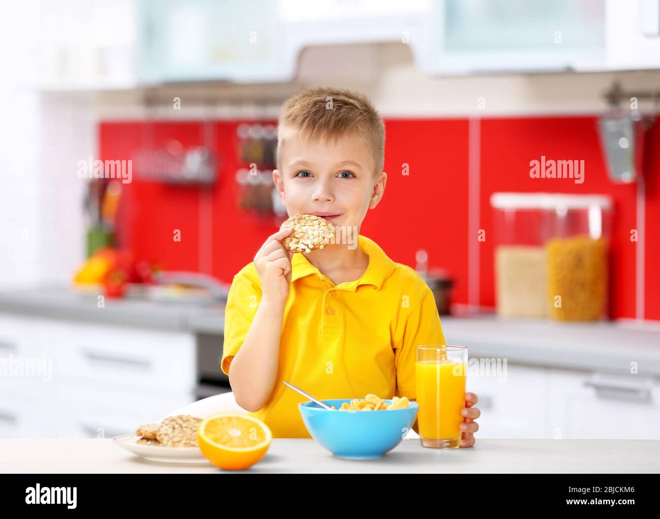 Little boy having breakfast in the kitchen Stock Photo - Alamy