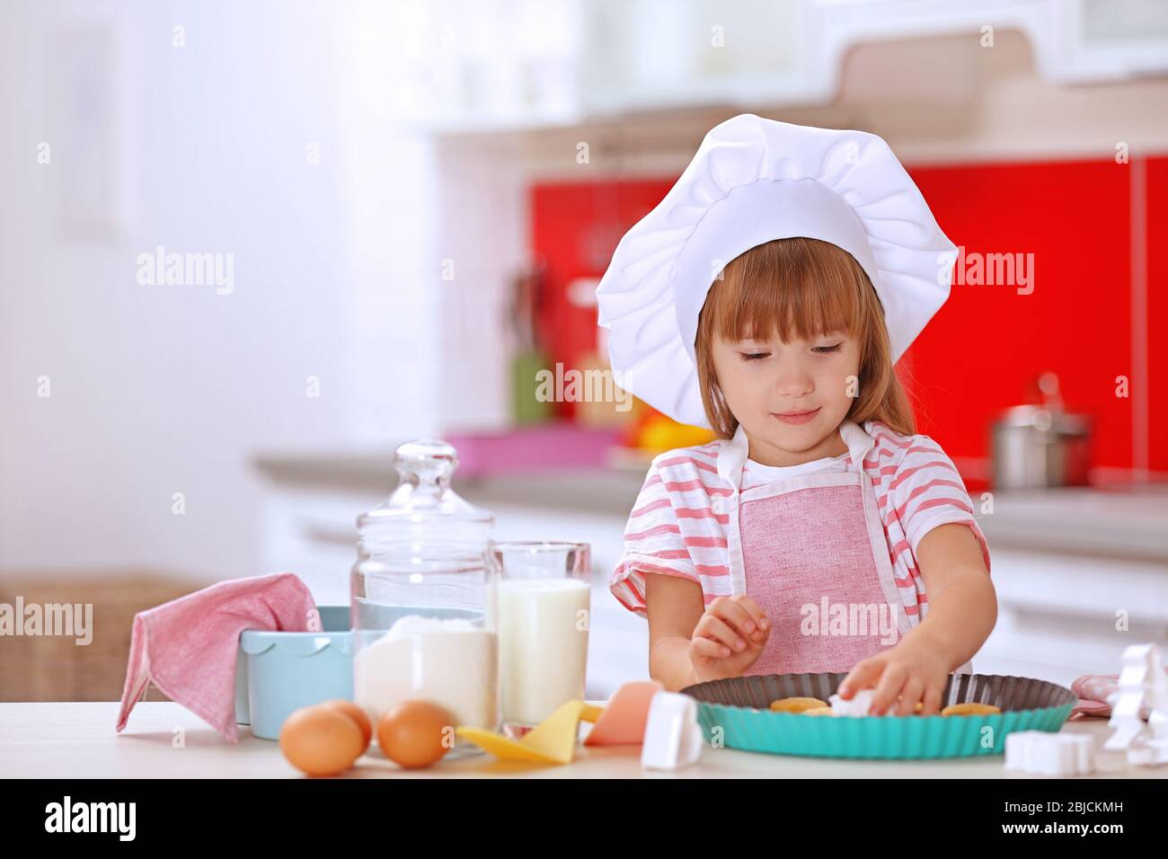 Little girl cooking in the kitchen Stock Photo - Alamy