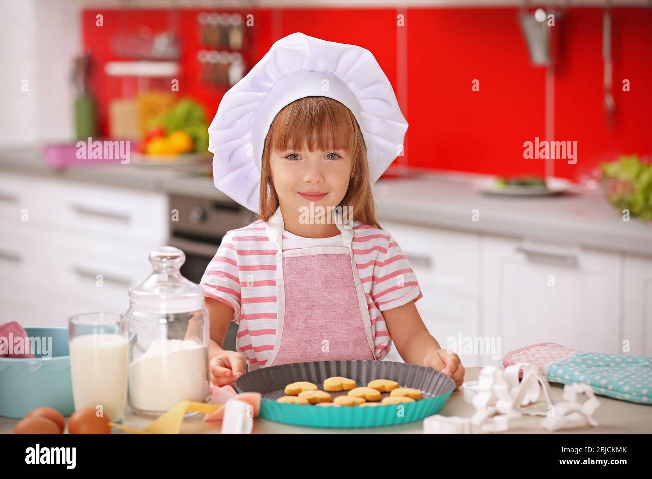 Little girl cooking in the kitchen Stock Photo - Alamy