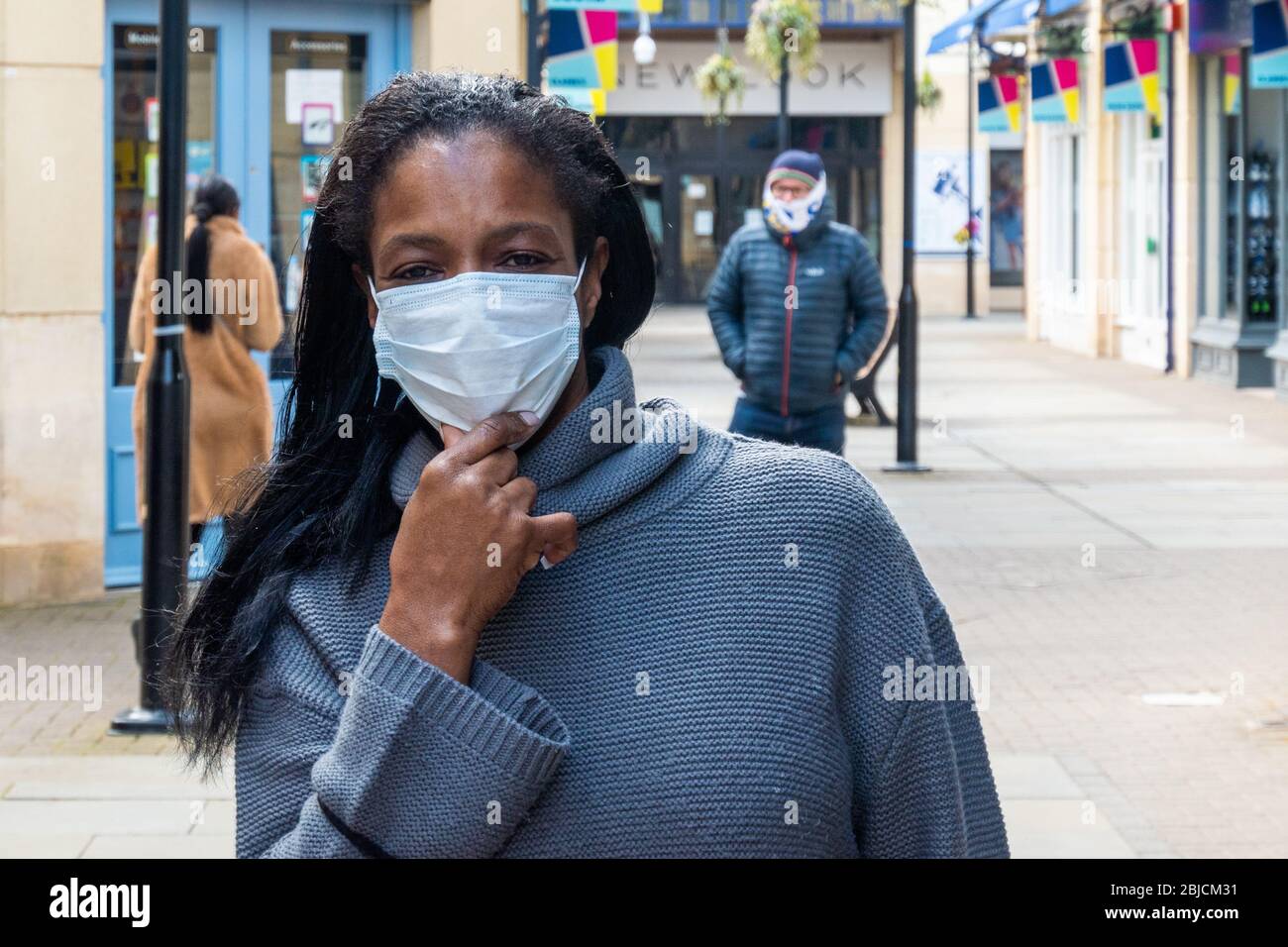 A woman poses in the street wearing a face mask Stock Photo - Alamy