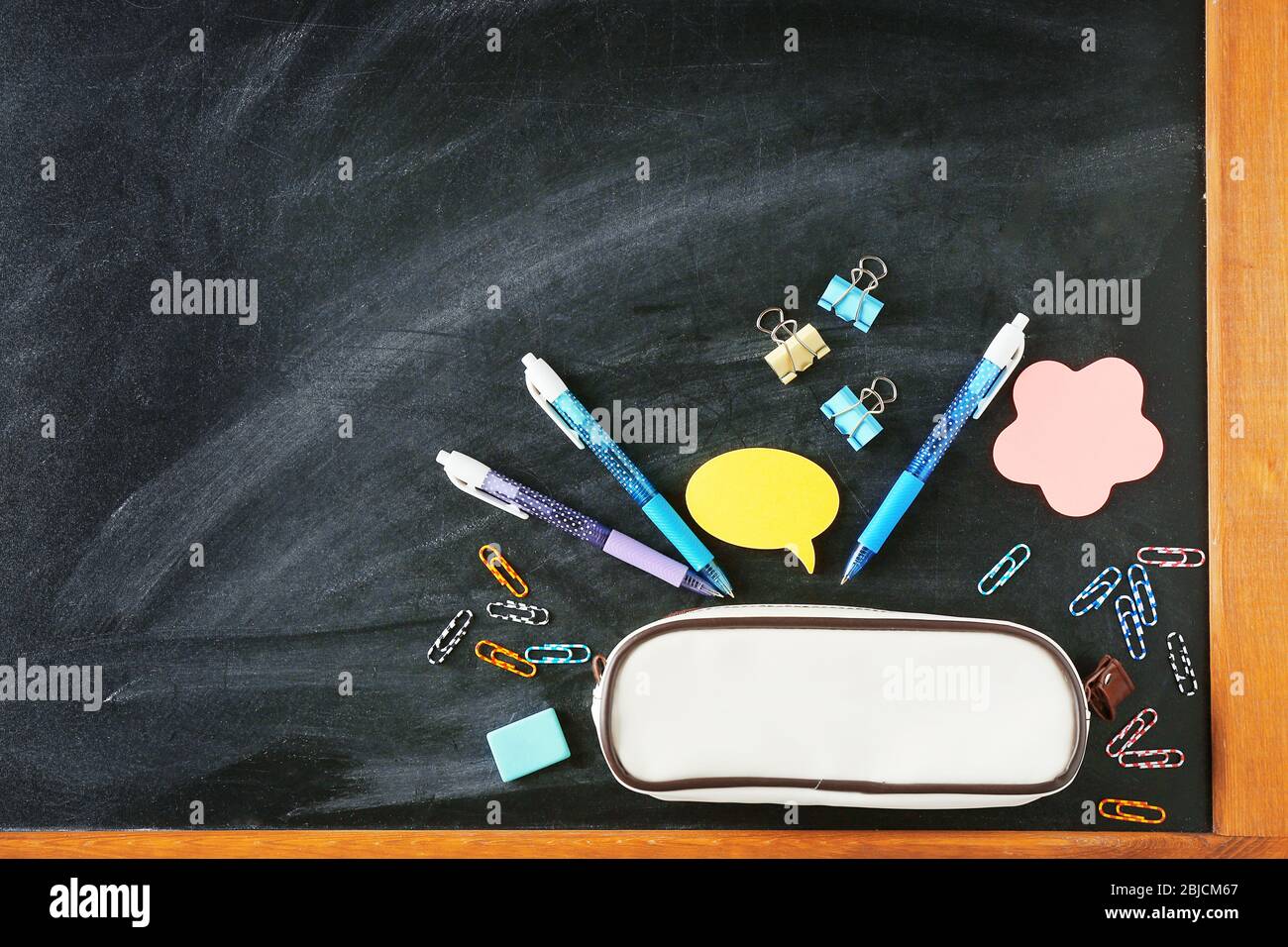 School stationery on blackboard, top view Stock Photo - Alamy