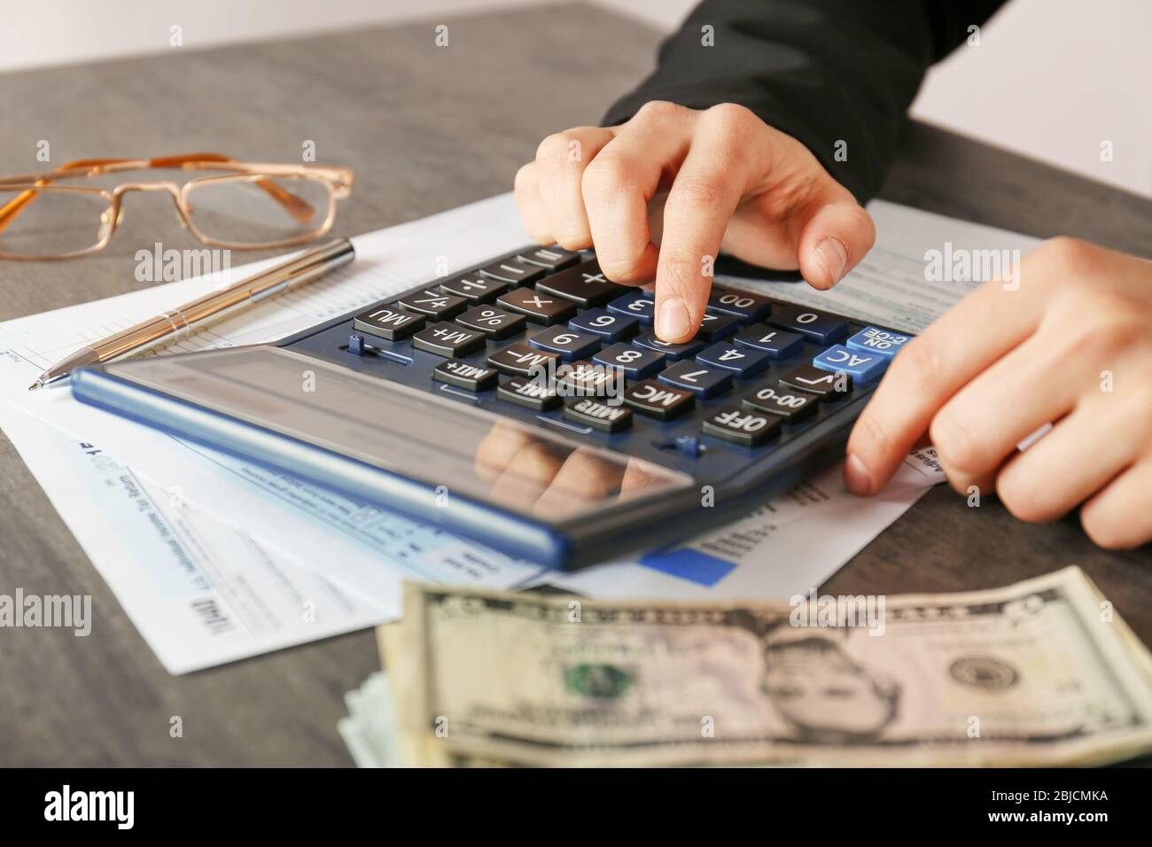 Female hands with calculator and individual income tax return form ...