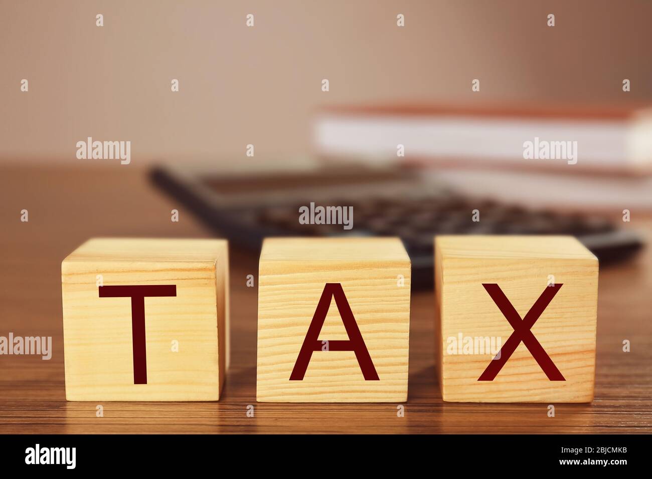 Wooden blocks with space for text on table, closeup. Tax concept Stock ...