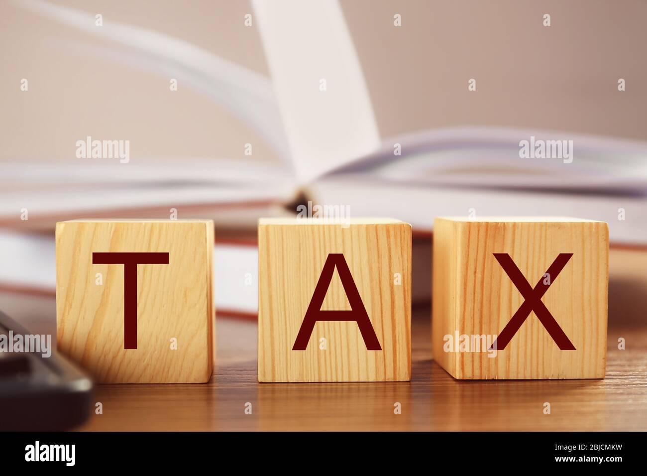Wooden blocks with space for text on table, closeup. Tax concept Stock ...