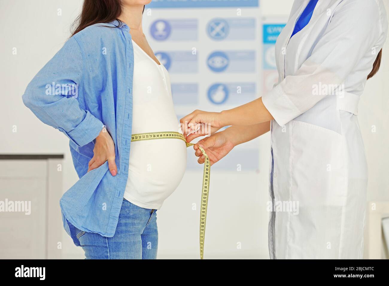 Doctor measuring pregnant belly Stock Photo - Alamy