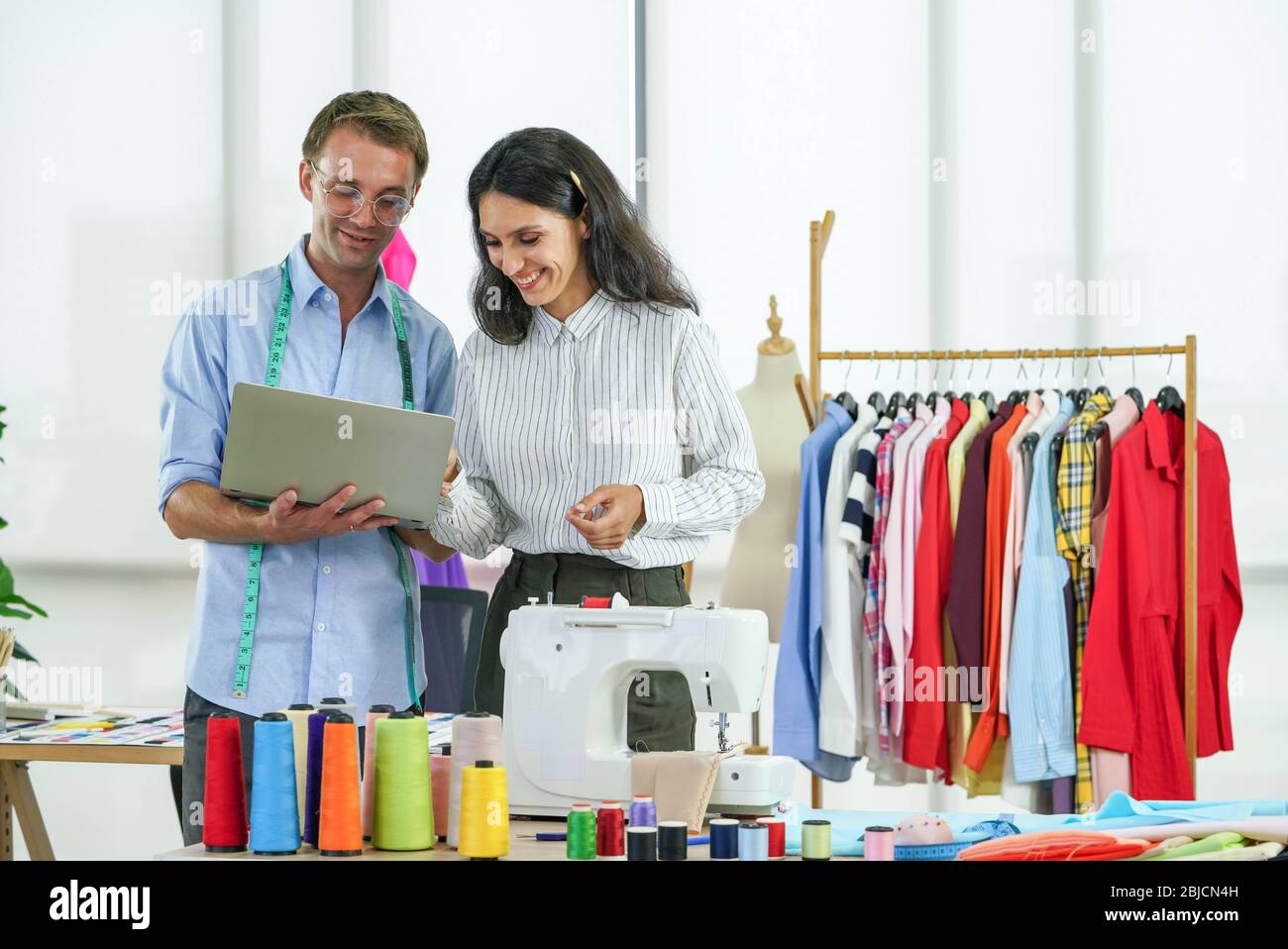 Fashion designer room, man and woman working in home base cloth design ...