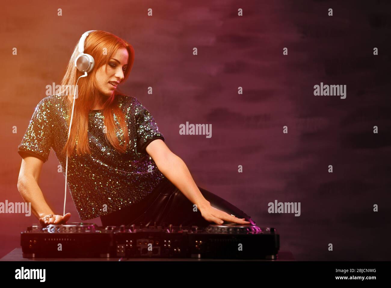DJ mixing music on color background Stock Photo - Alamy