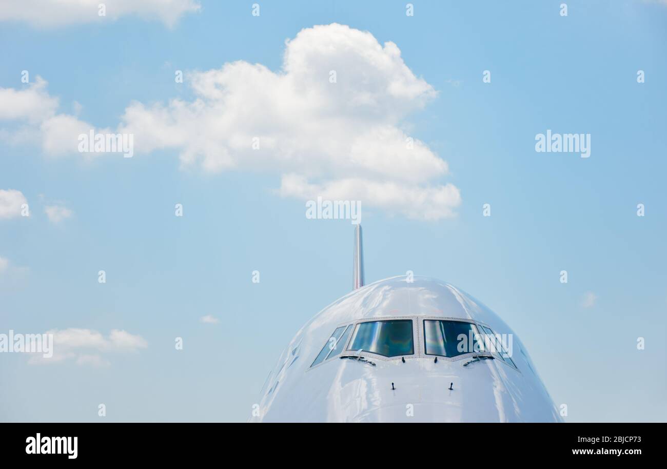 Front view of airplane's cockpit in the sky with clouds Stock Photo - Alamy