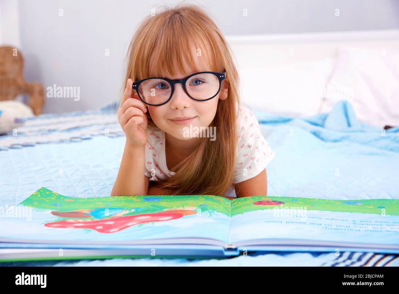 Little cute girl reading book Stock Photo - Alamy