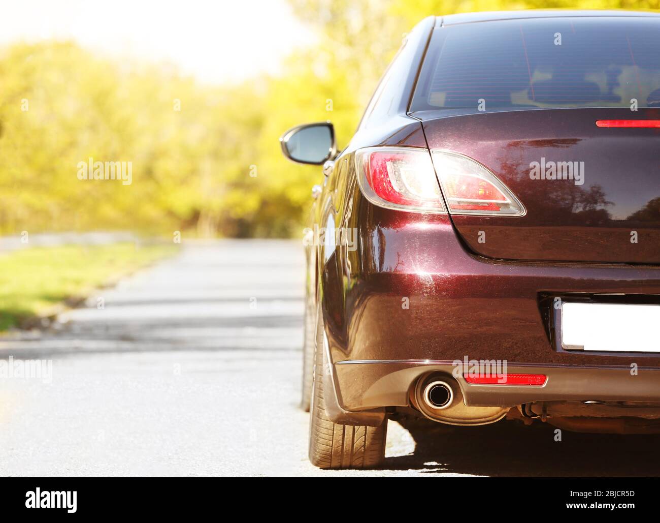 Rear view of modern car on road Stock Photo - Alamy