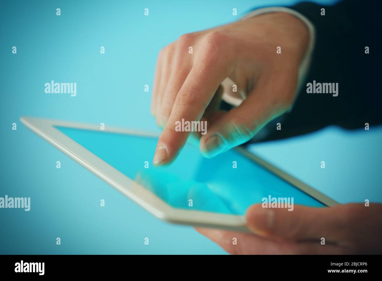 Male finger touching tablet screen on blurred background Stock Photo ...