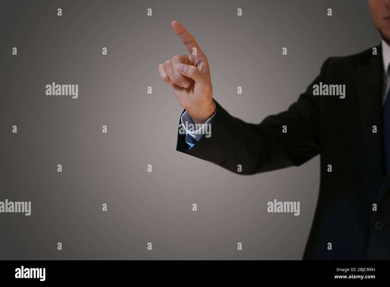 Male hand with finger pointing on dark background Stock Photo - Alamy