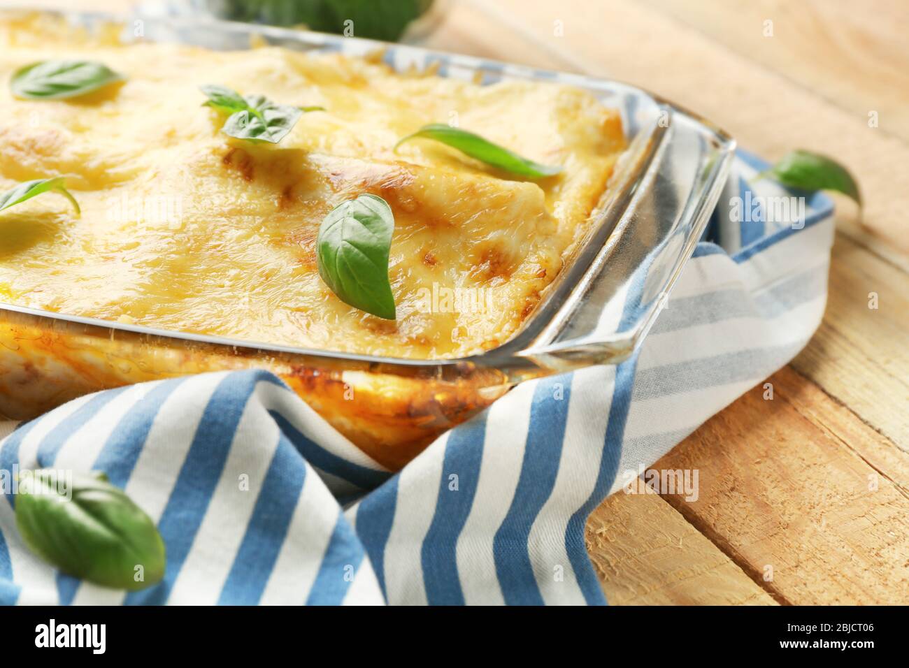 Traditional lasagna in glass baking dish and napkin, closeup Stock ...