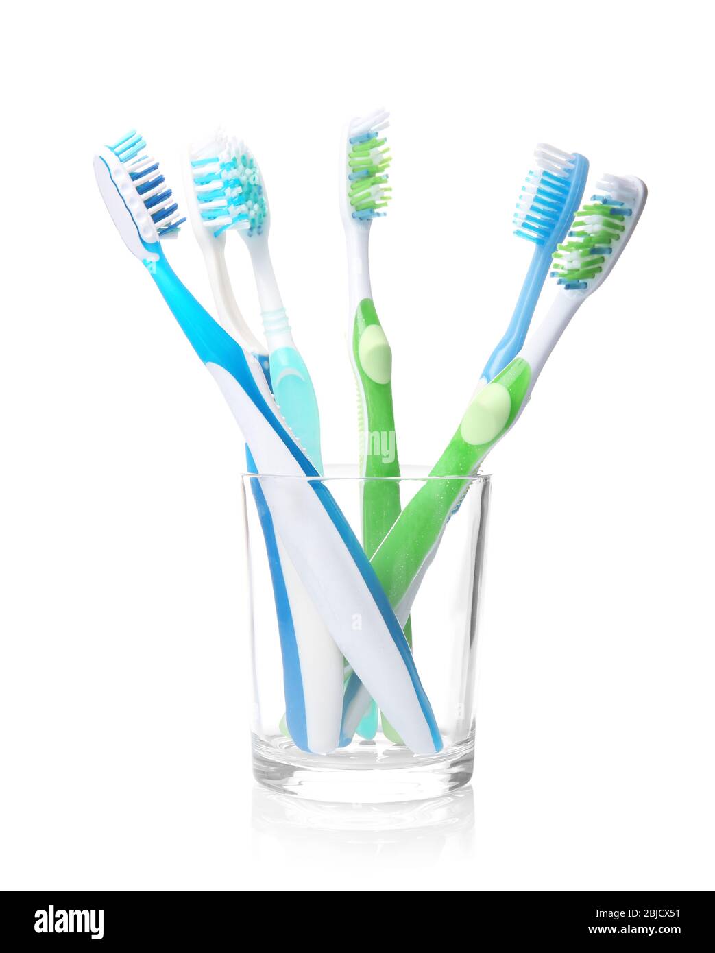 Toothbrushes in glass on white background Stock Photo - Alamy