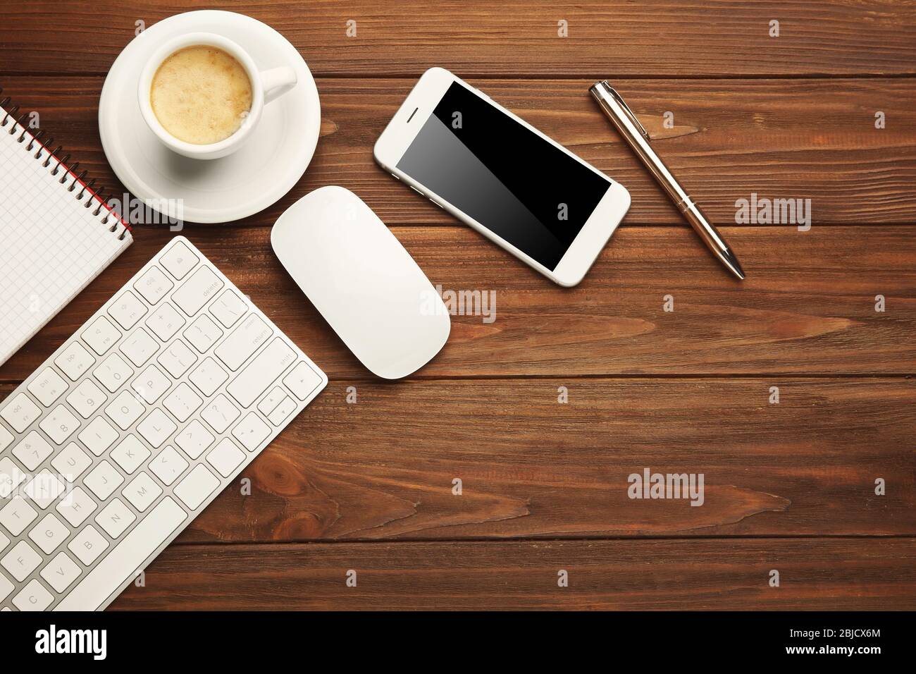 Computer keyboard, phone and cup of coffee on wooden background Stock ...