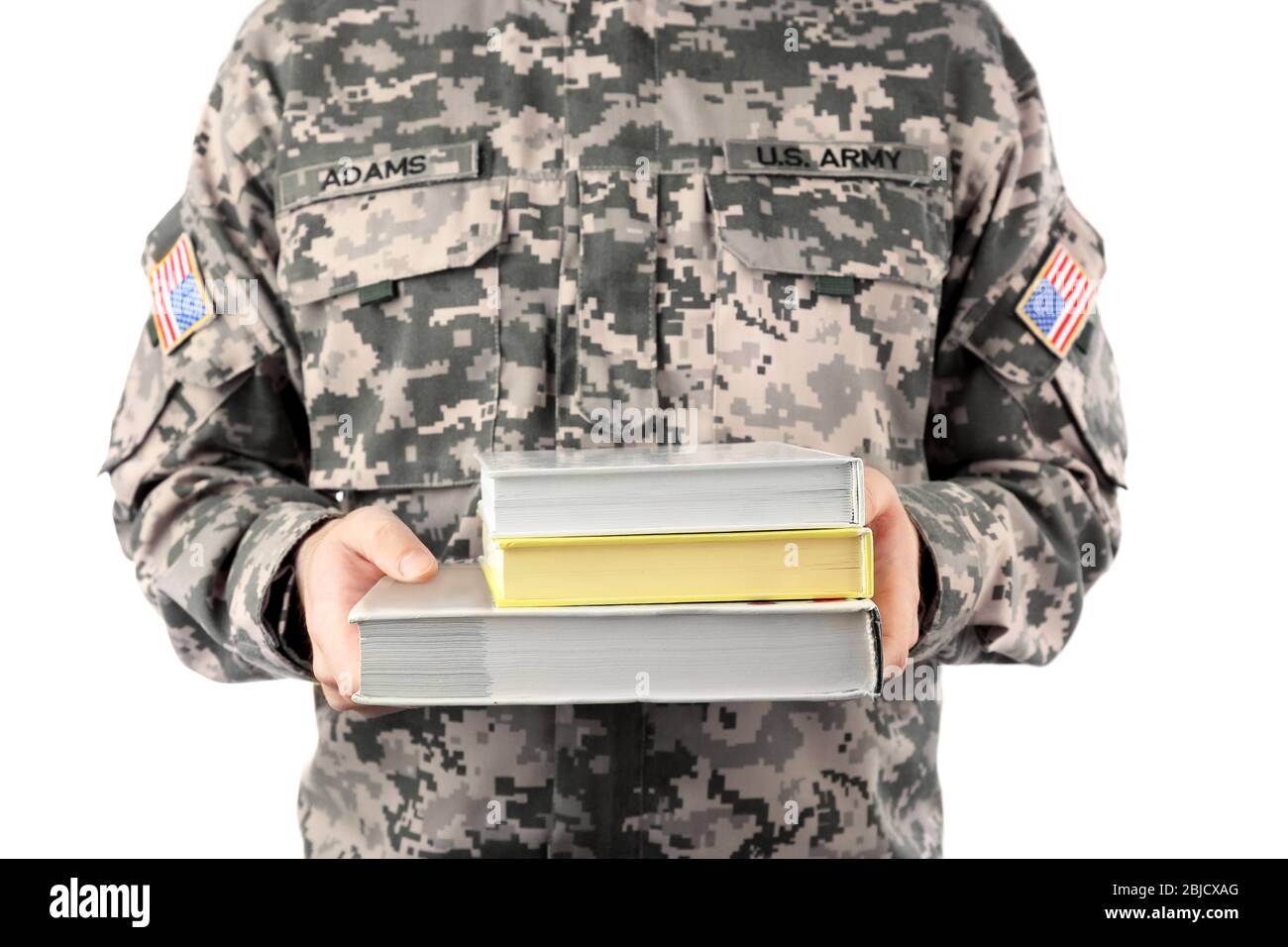 Soldier holding books. Military education concept Stock Photo - Alamy