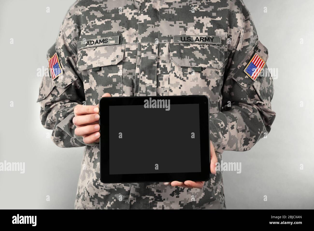 Soldier holding tablet. Military education concept Stock Photo - Alamy