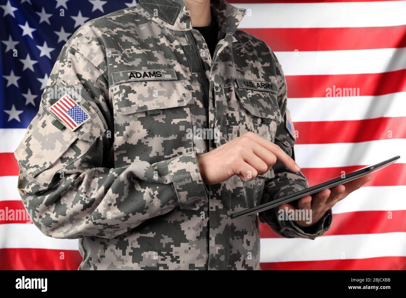 Soldier holding tablet. Military education concept Stock Photo - Alamy