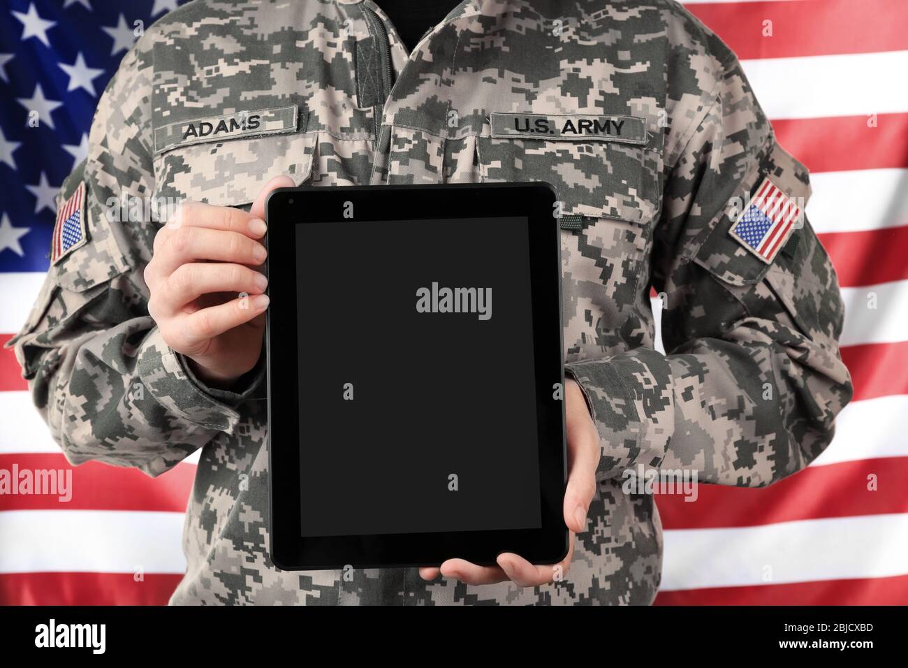Soldier holding tablet. Military education concept Stock Photo - Alamy