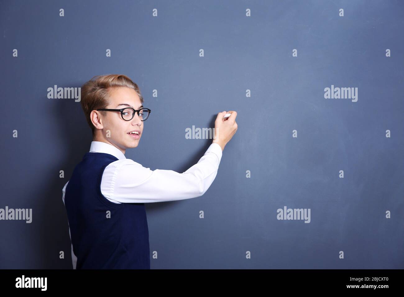 Pupil standing near school blackboard Stock Photo - Alamy