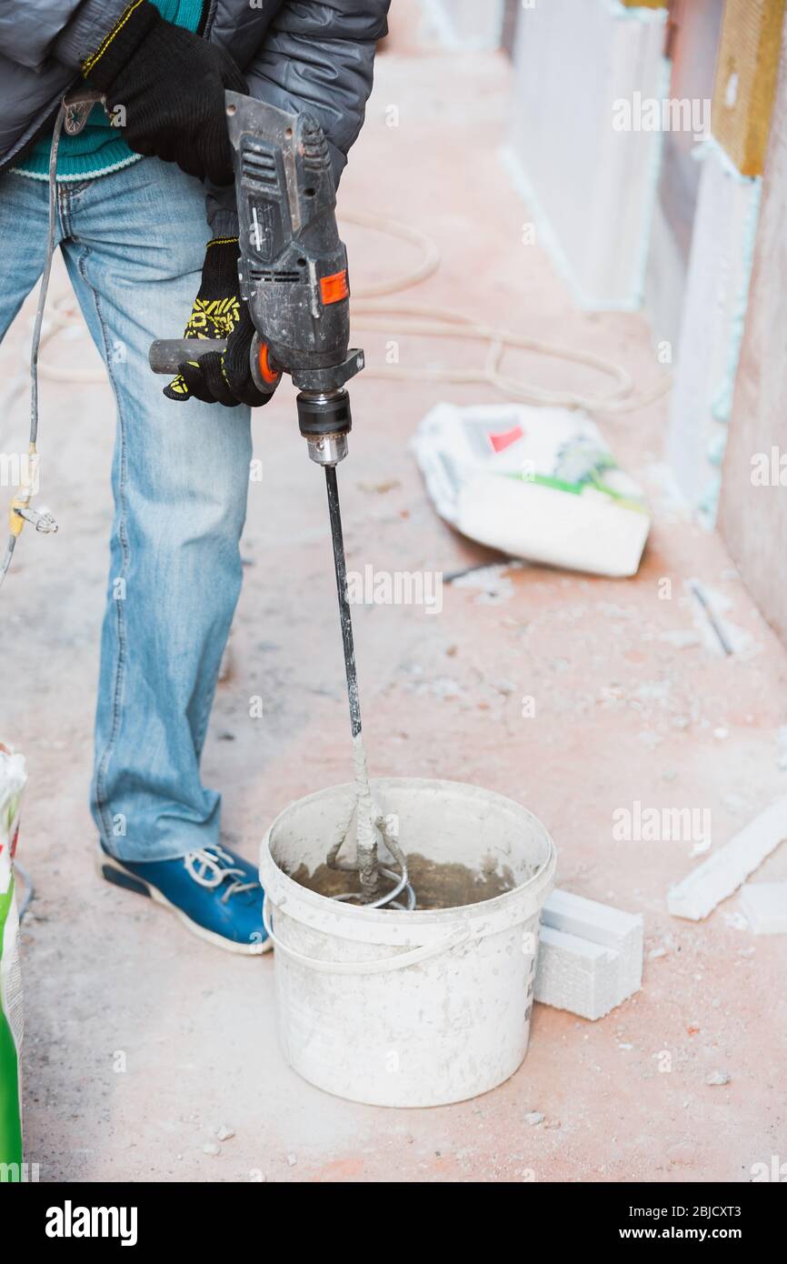 Closeup of repairman in uniform, professional builder working using ...