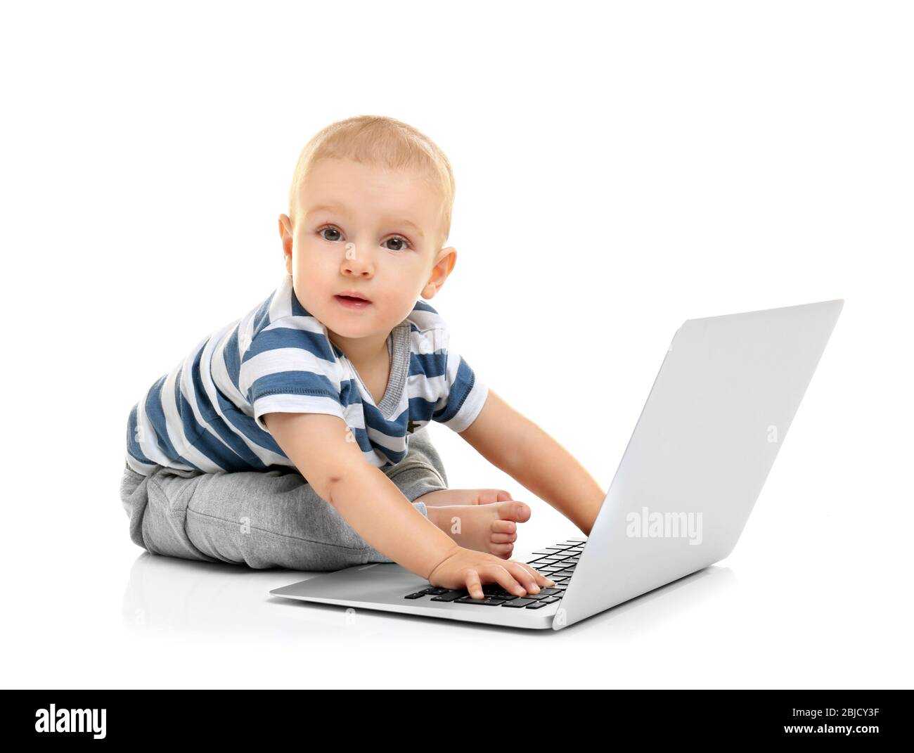 Cute baby boy with laptop on white background Stock Photo - Alamy