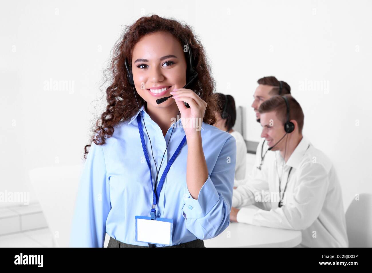 Young female technical support dispatcher working in office, closeup ...