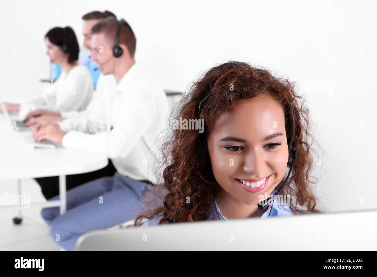 Young female technical support dispatcher working in office, closeup ...