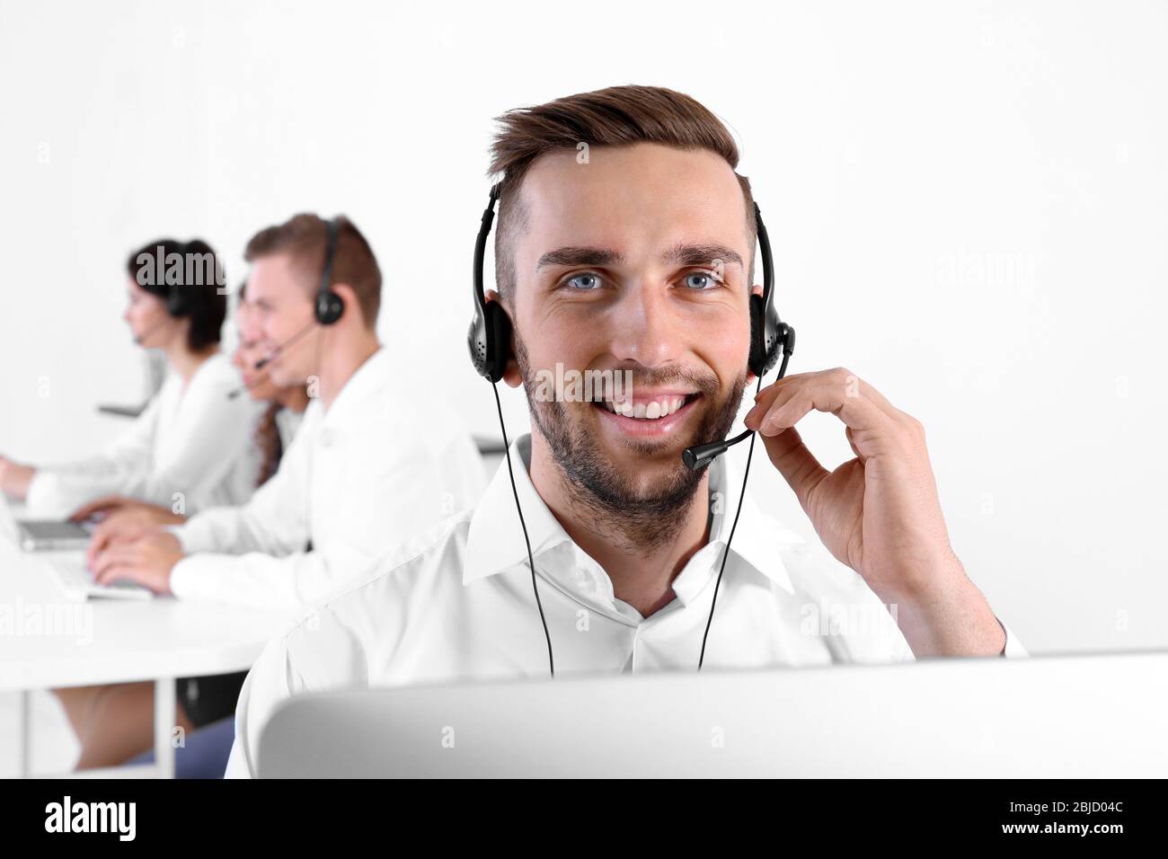 Young male technical support dispatcher working in office, closeup ...