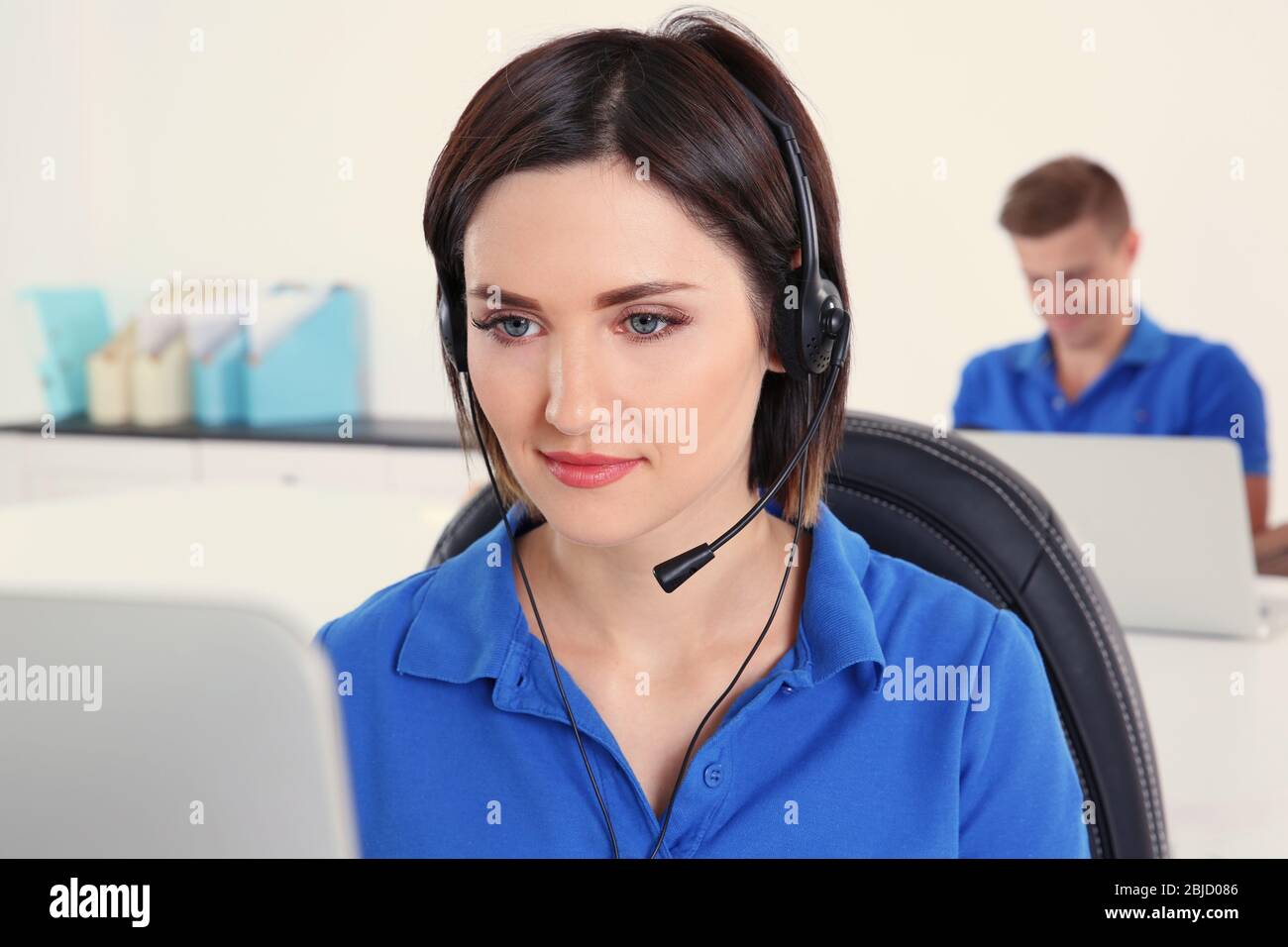Young beautiful technical support dispatcher working in office, closeup ...
