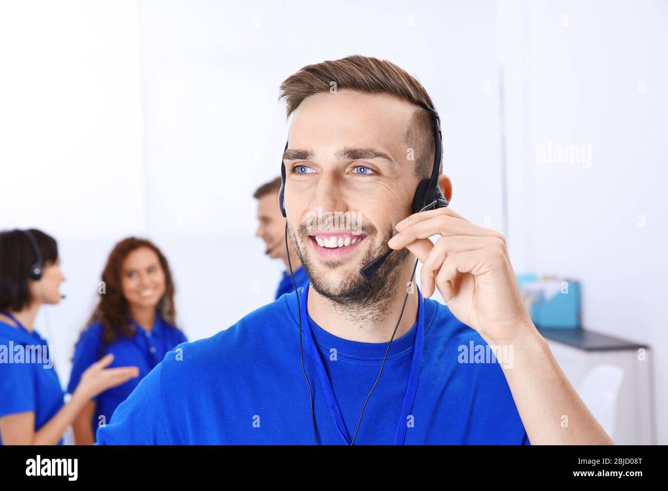 Young male technical support dispatcher working in office Stock Photo ...