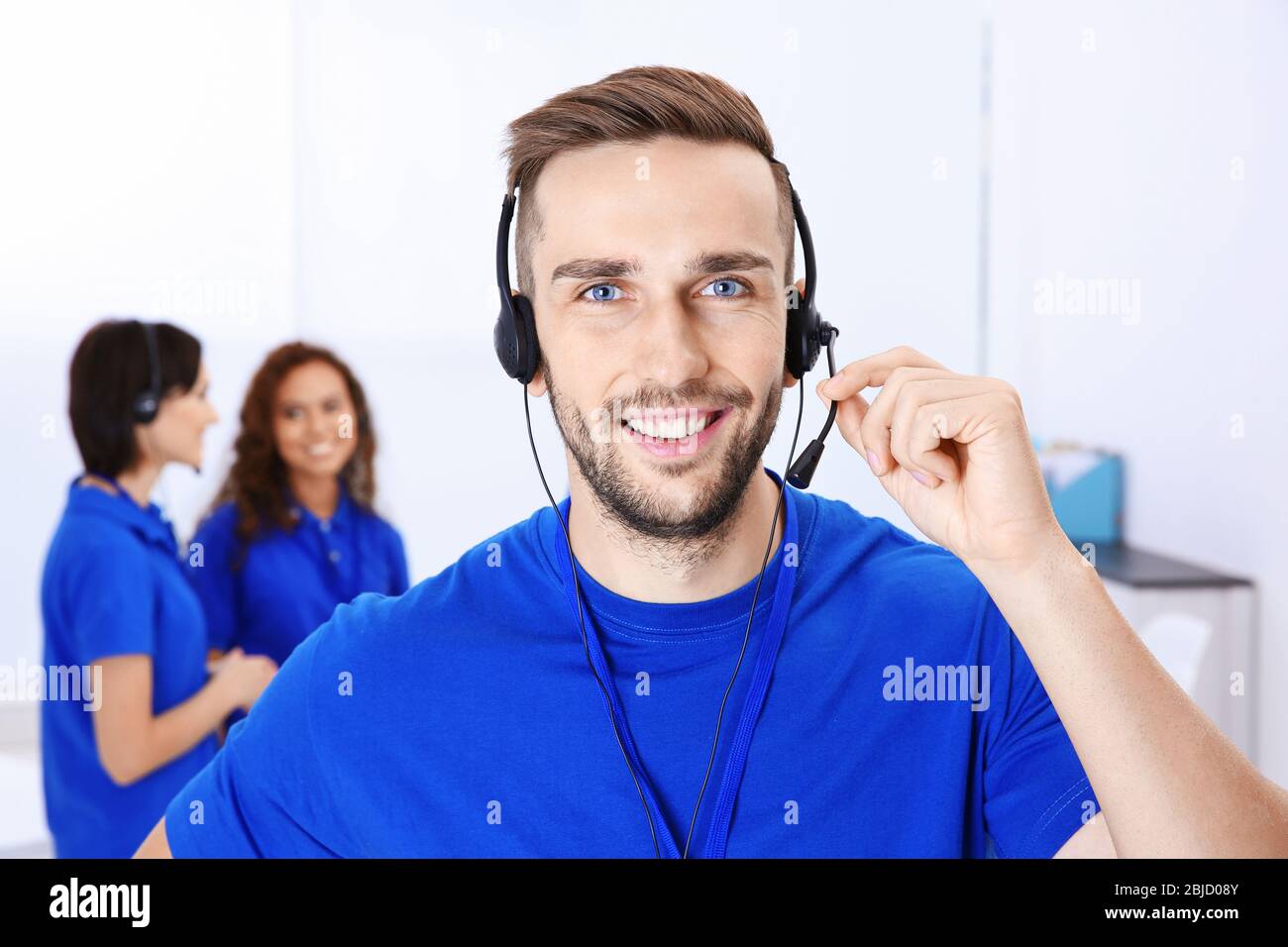 Young male technical support dispatcher working in office Stock Photo ...