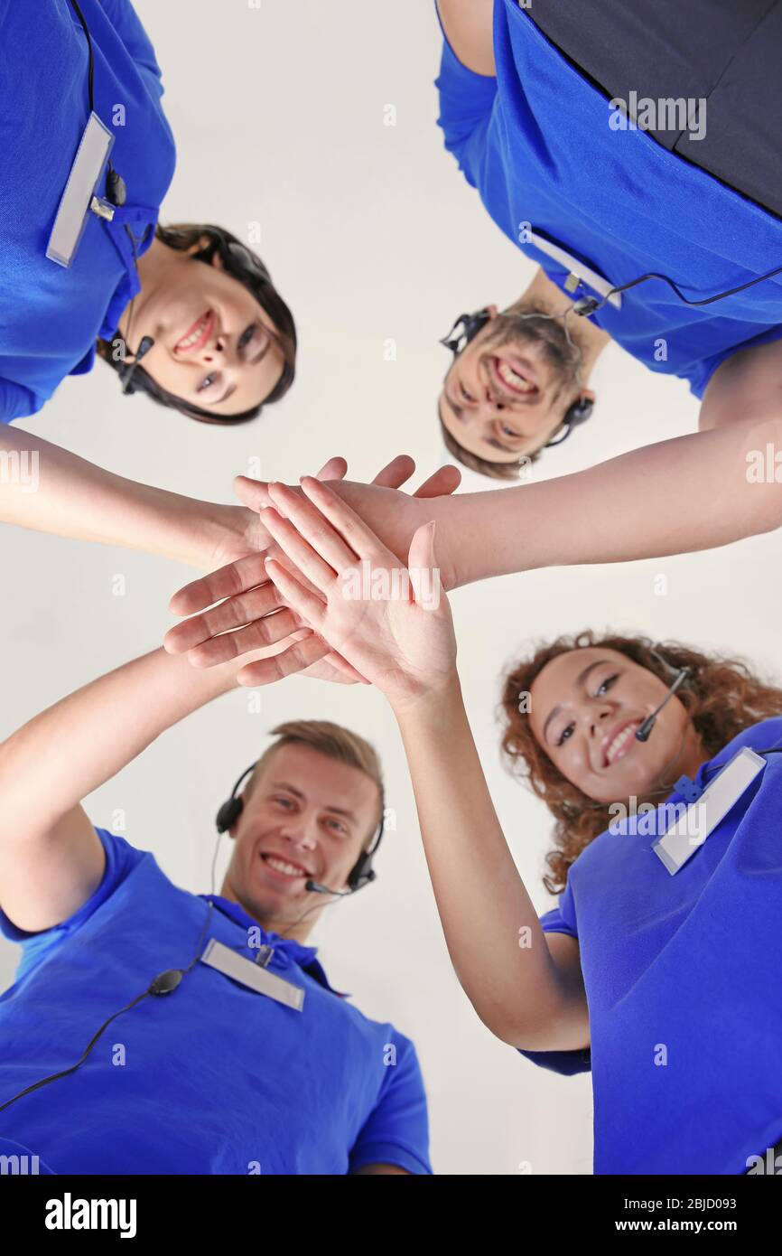 Team of technical support dispatchers holding hands together Stock ...