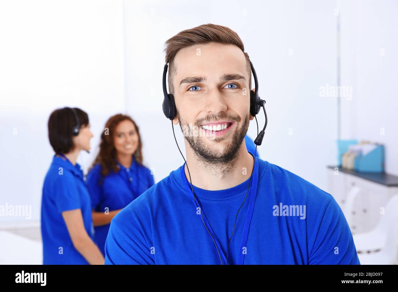 Young male technical support dispatcher working in office Stock Photo ...