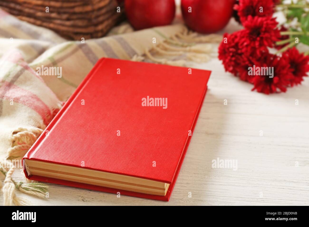 Red book with warm plaid on the table Stock Photo - Alamy