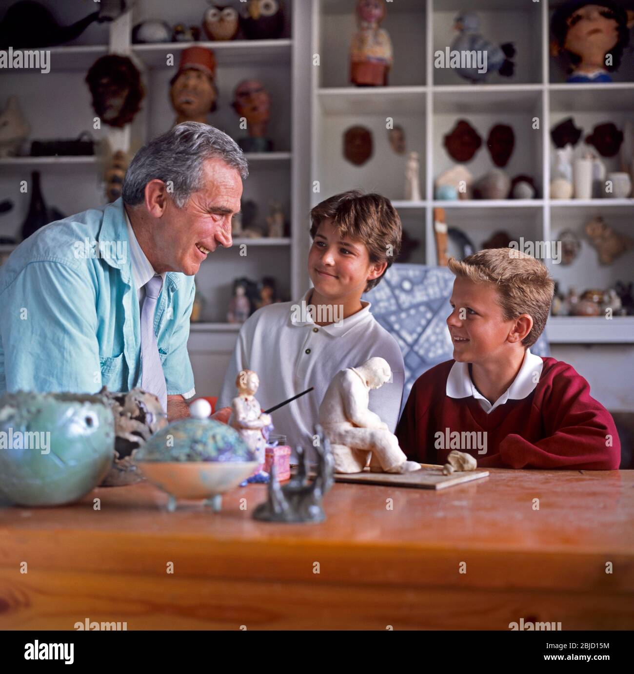 Art pottery school classroom with teacher and two junior schoolboys 10 ...