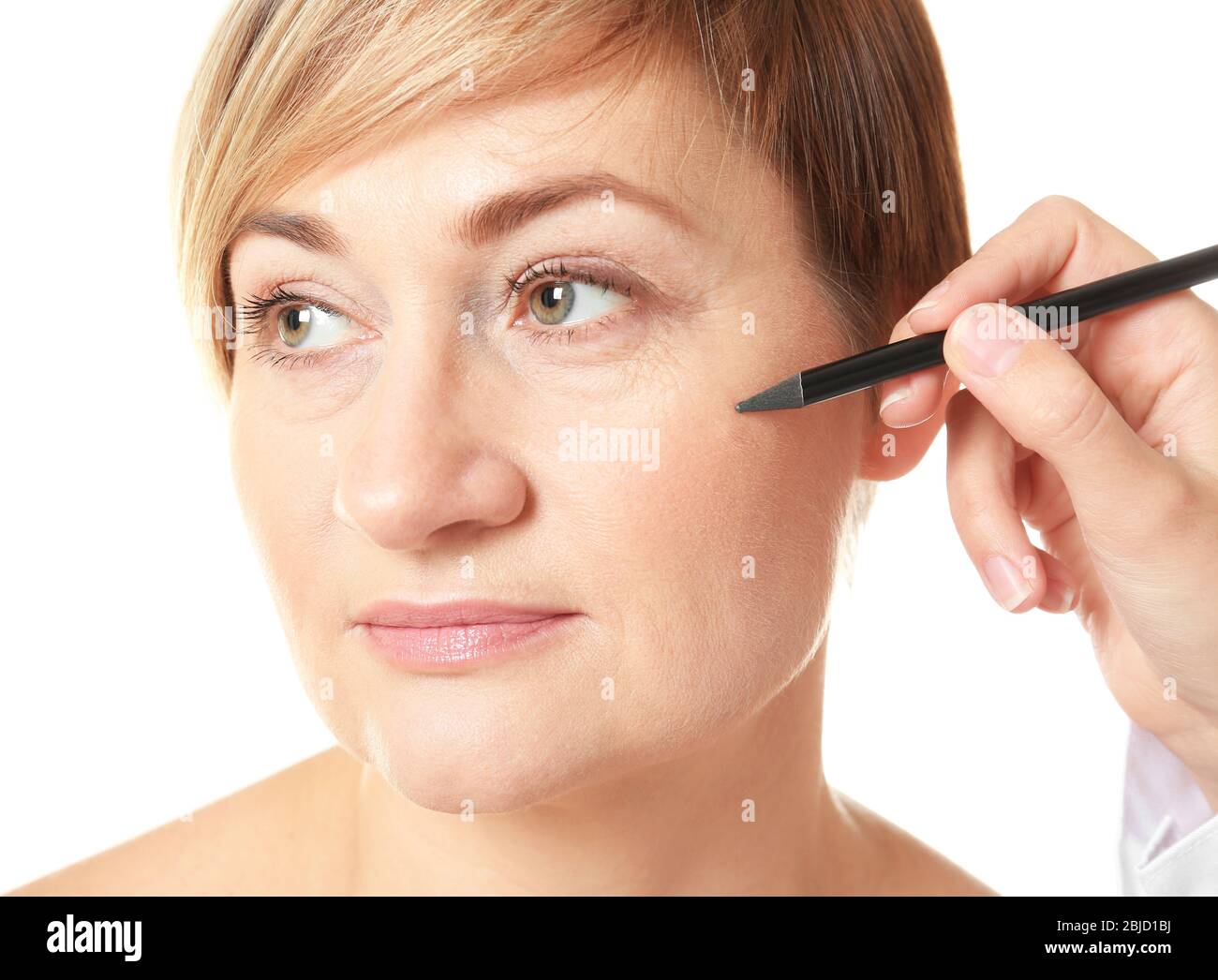 Surgeon hand drawing marks on female face for plastic operation Stock ...