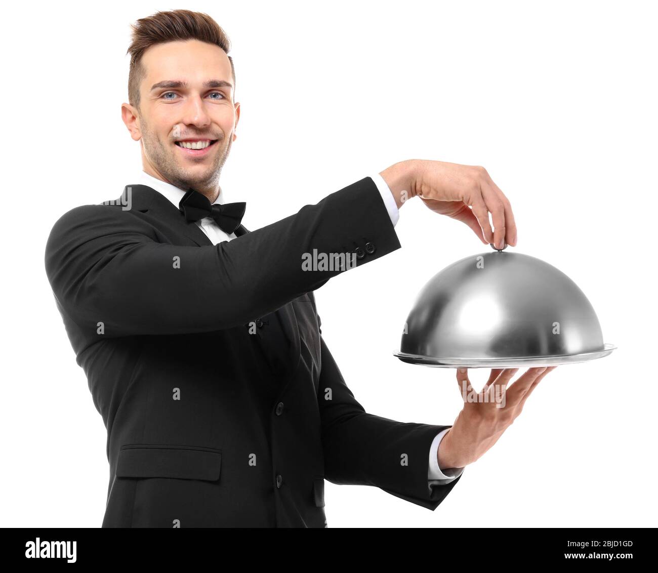 Handsome waiter holding metal tray with cover on white background Stock ...