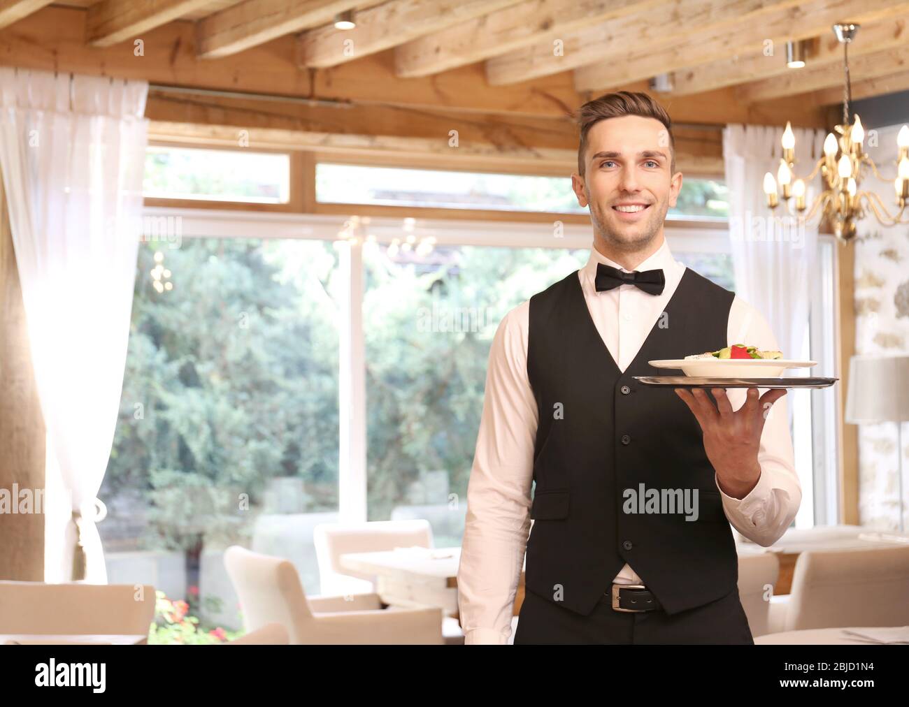 Handsome waiter restaurant interior hi-res stock photography and images ...