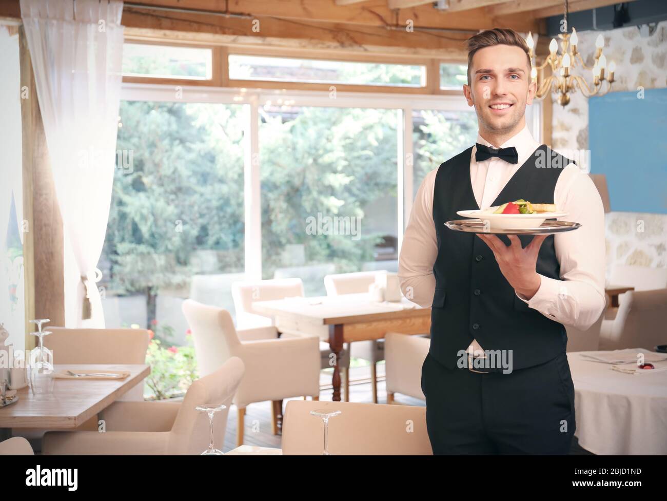 Handsome waiter restaurant interior hi-res stock photography and images ...