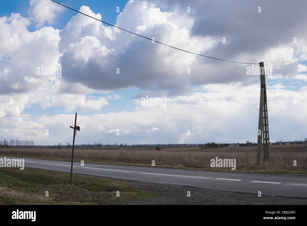 landscape with holy cross and power line pole over dark clouds Stock ...
