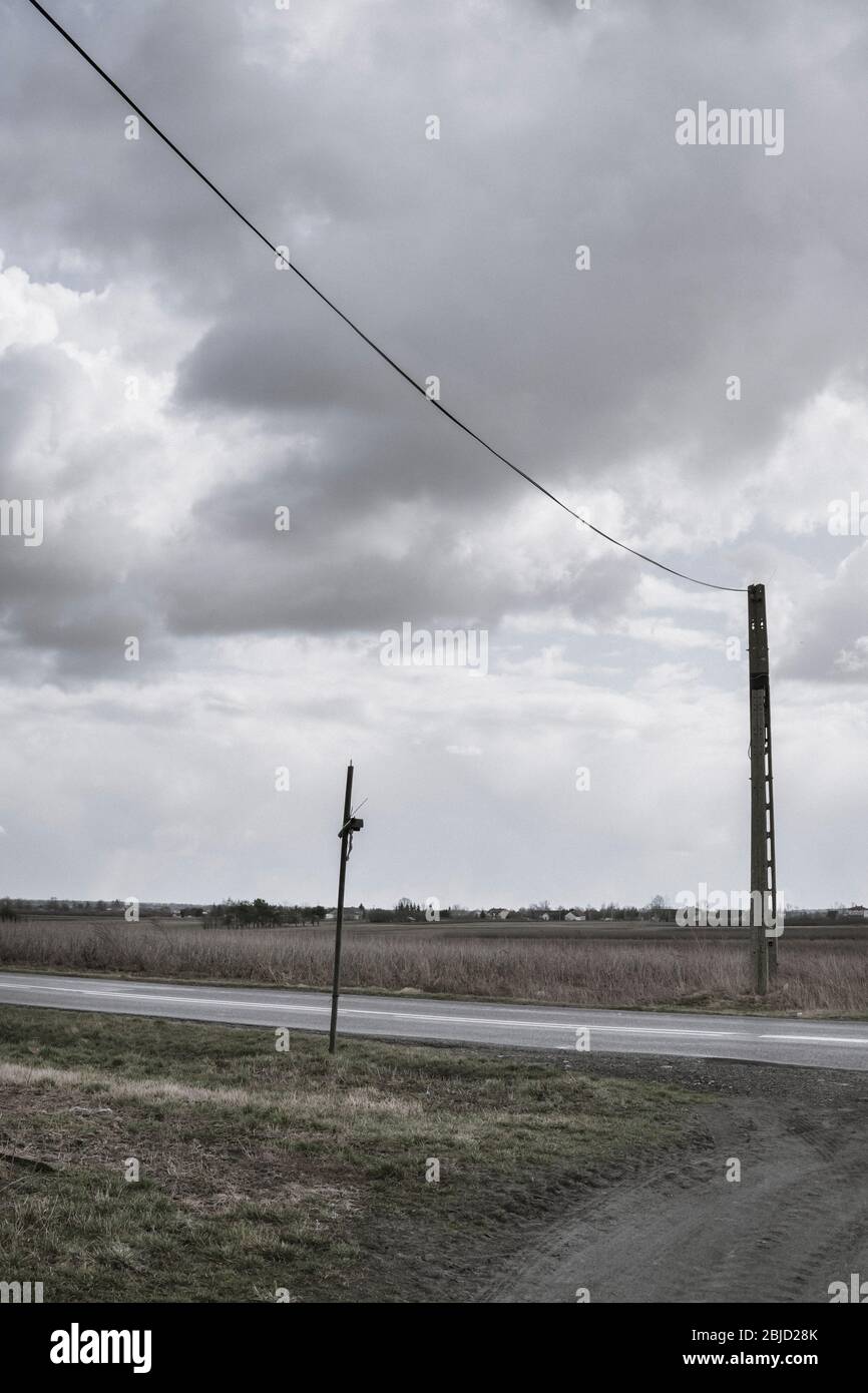 landscape with holy cross and power line pole over dark clouds Stock ...