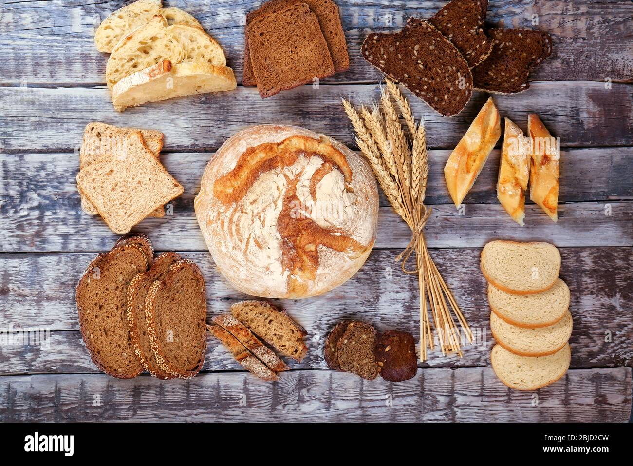 Different types of fresh bread on wooden background Stock Photo - Alamy