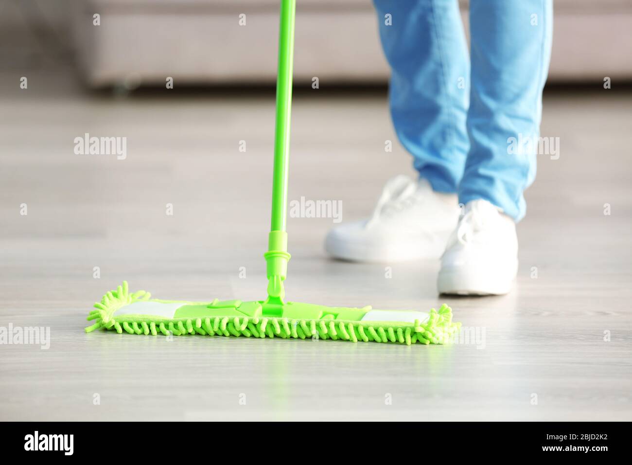 Woman moping the floor hi-res stock photography and images - Alamy