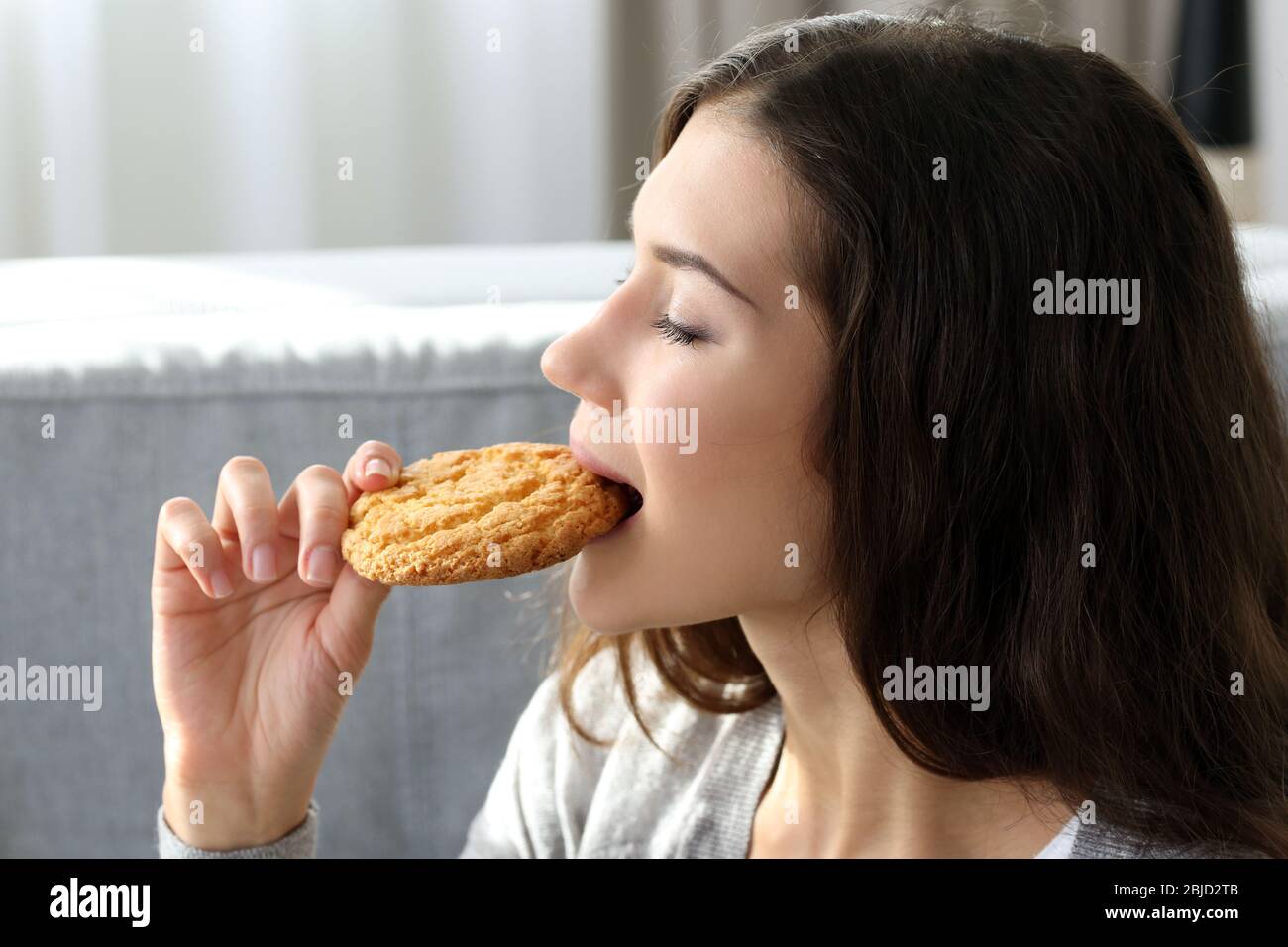 Woman eating biscuit close hi-res stock photography and images - Alamy