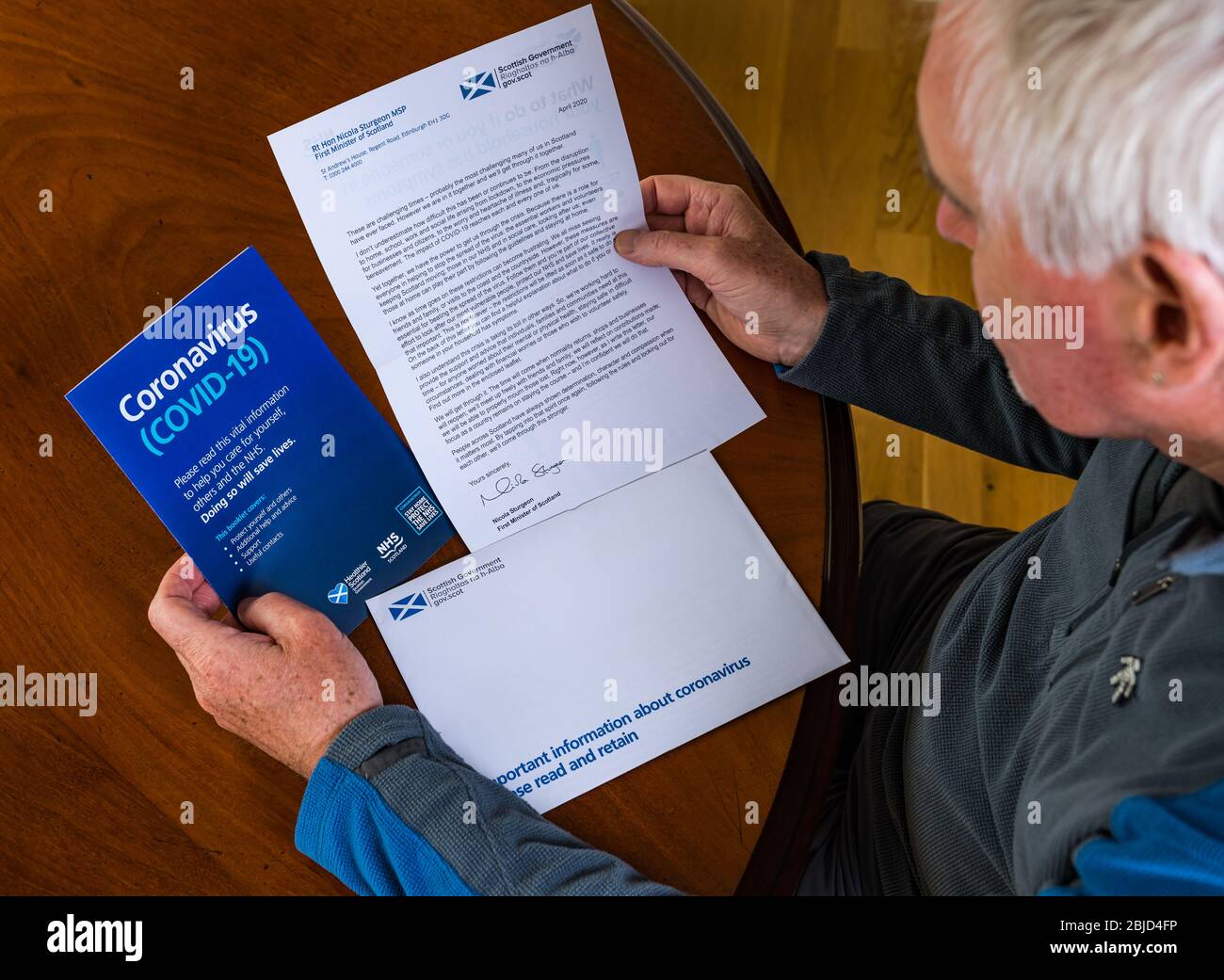 Older man reading leaflet hi-res stock photography and images - Alamy