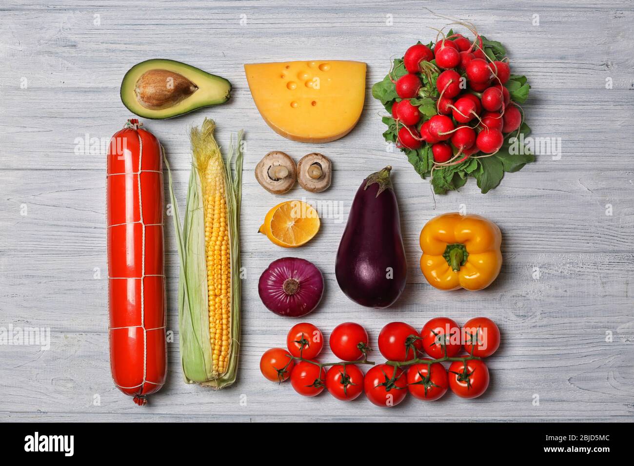 Variety of food products on kitchen table Stock Photo - Alamy