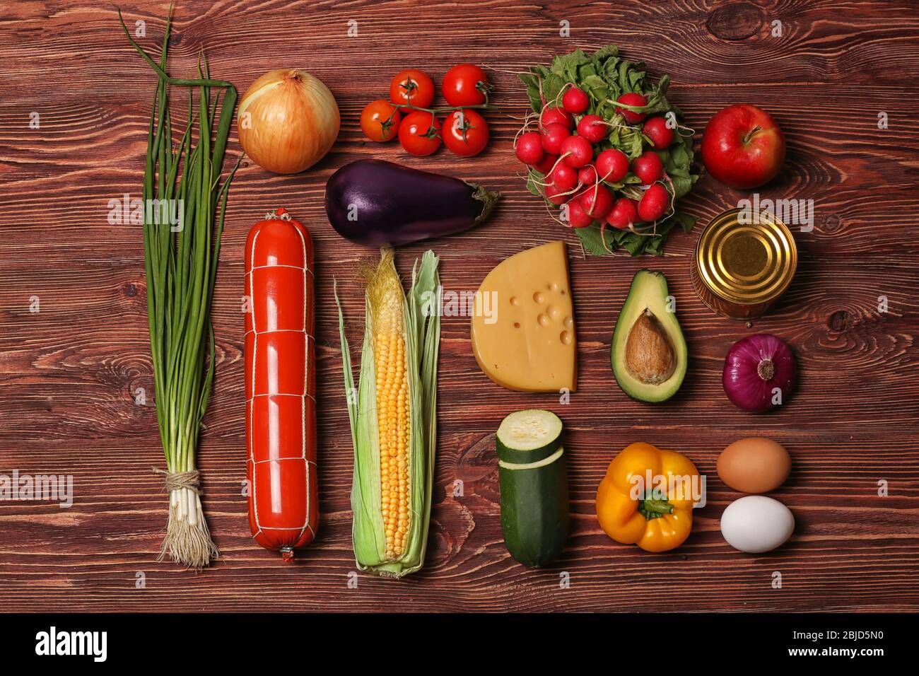 Variety of food products on kitchen table Stock Photo - Alamy